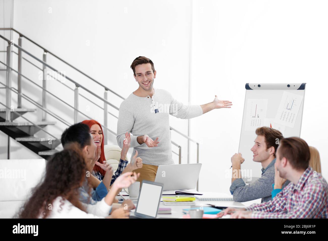 Young man making a presentation on a board in the office Stock Photo ...