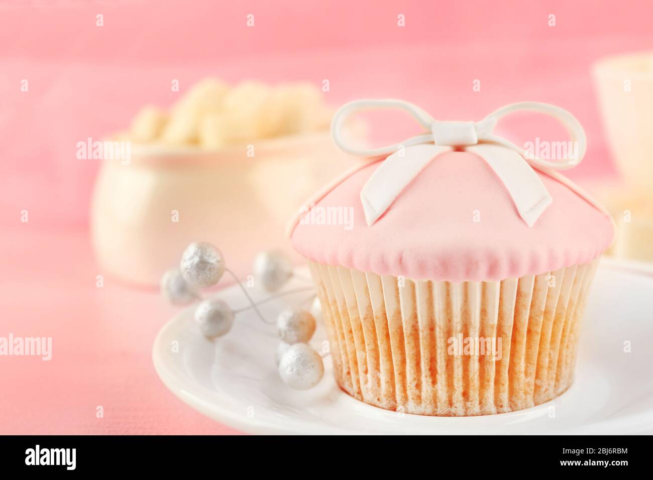 Tasty pink cupcake with decorations, closeup Stock Photo - Alamy