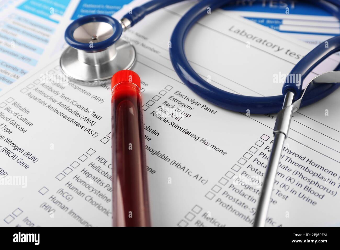 Blood in test tubes, stethoscope and investigation form on the table ...