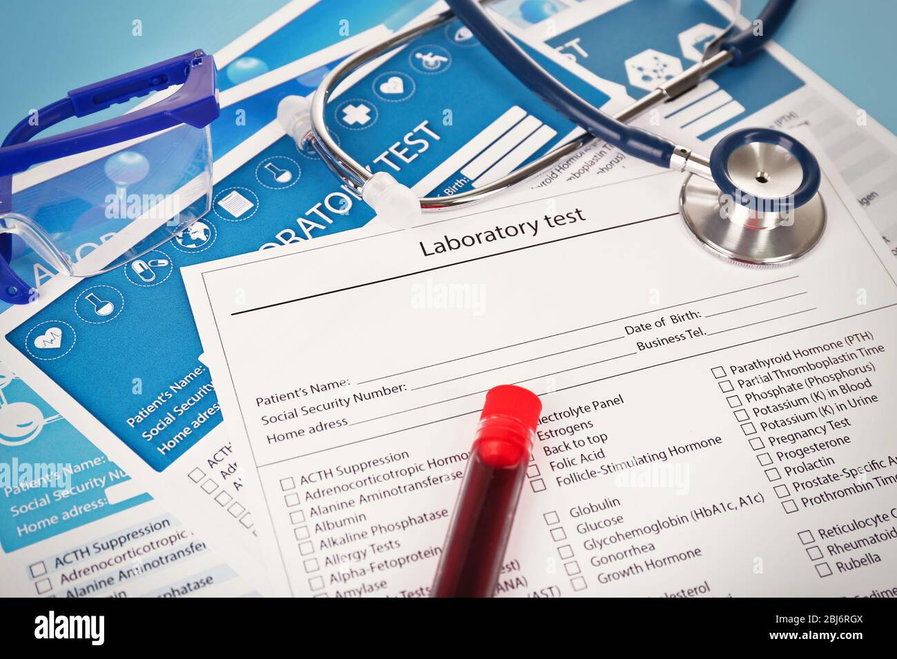 Blood in test tubes, stethoscope, glasses and investigation form on the ...
