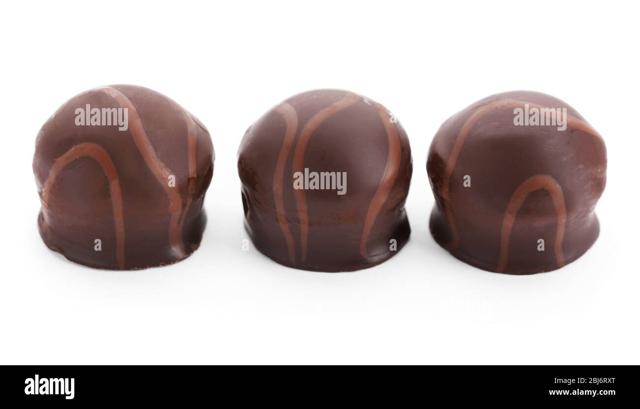 Three chocolate candies, isolated on white Stock Photo - Alamy
