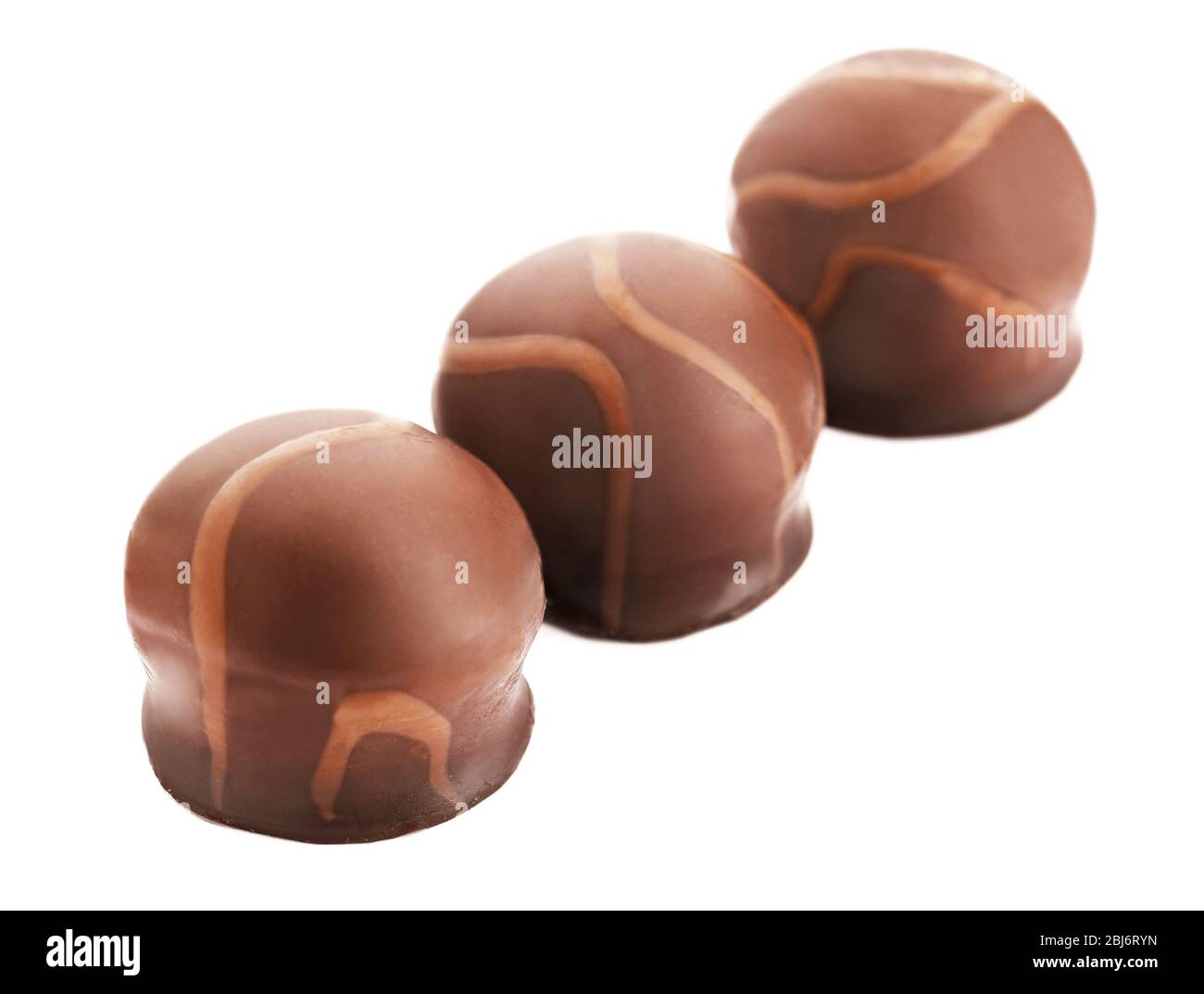 Three chocolate candies, isolated on white Stock Photo - Alamy