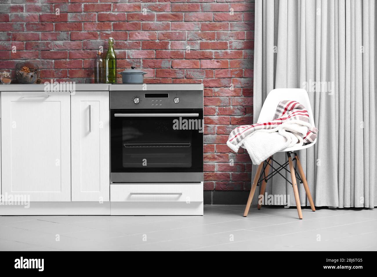 Modern kitchen furniture against brick wall background Stock Photo - Alamy