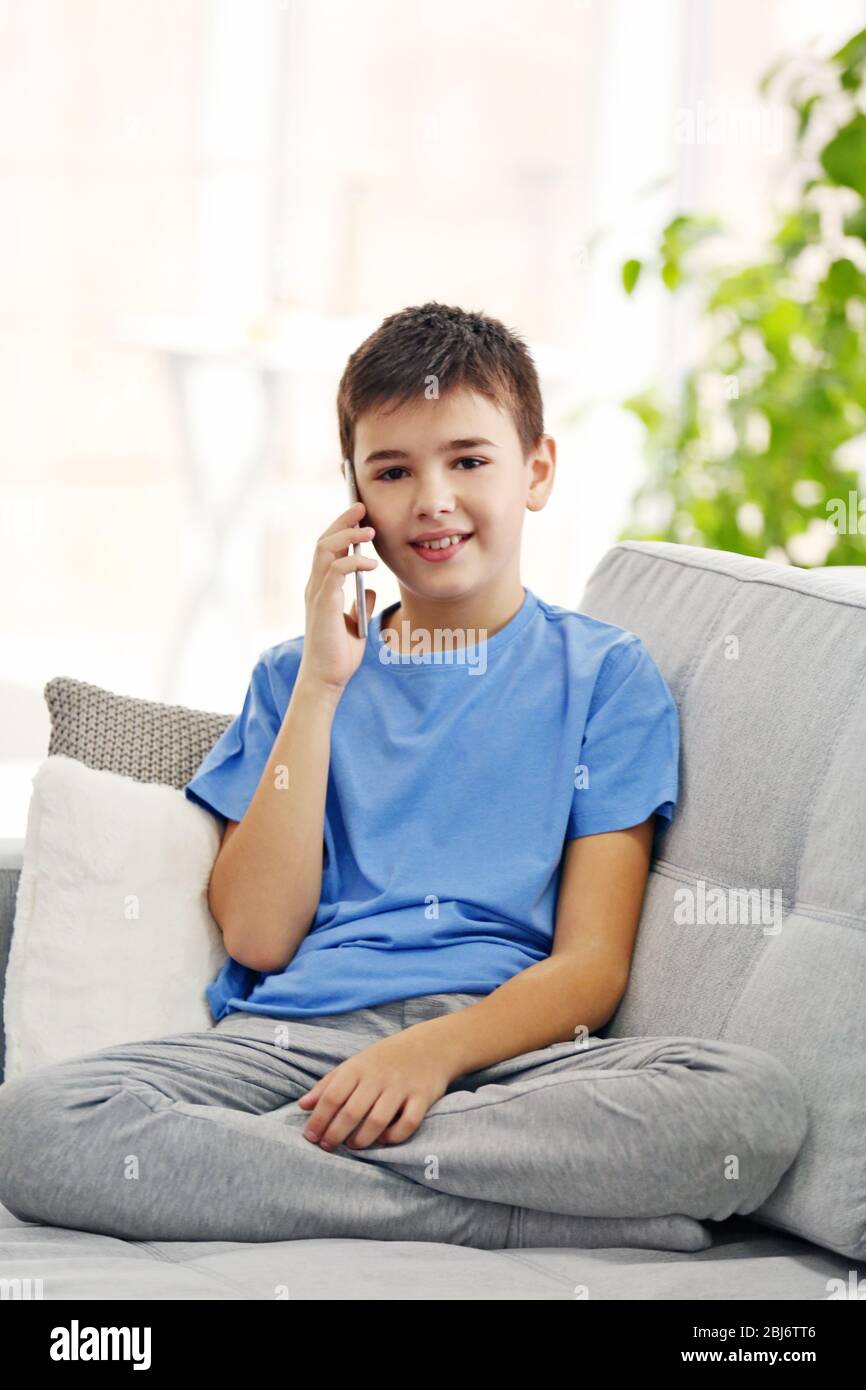 Boy using his mobile phone at home Stock Photo - Alamy