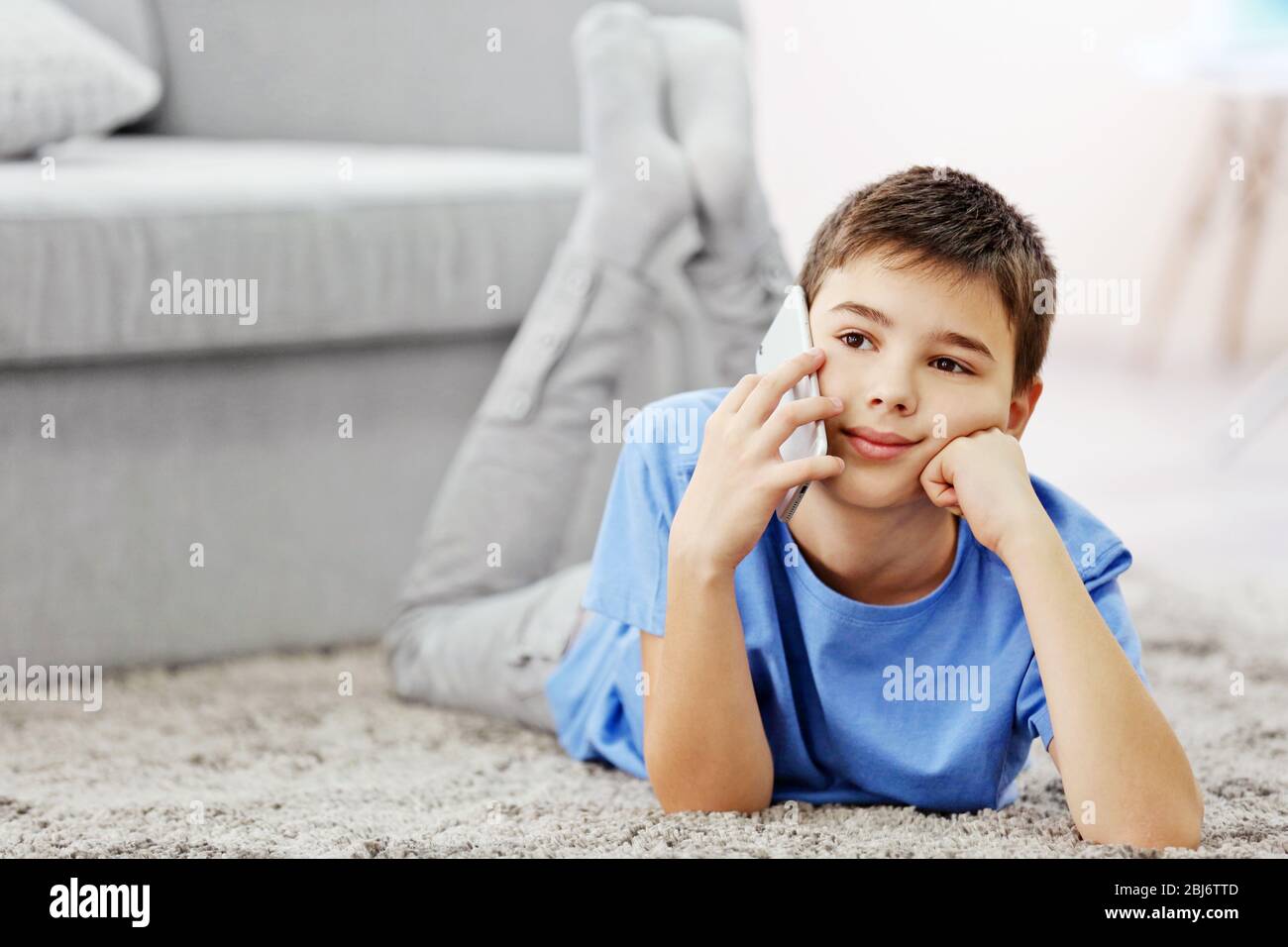 Boy using his mobile phone at home Stock Photo - Alamy