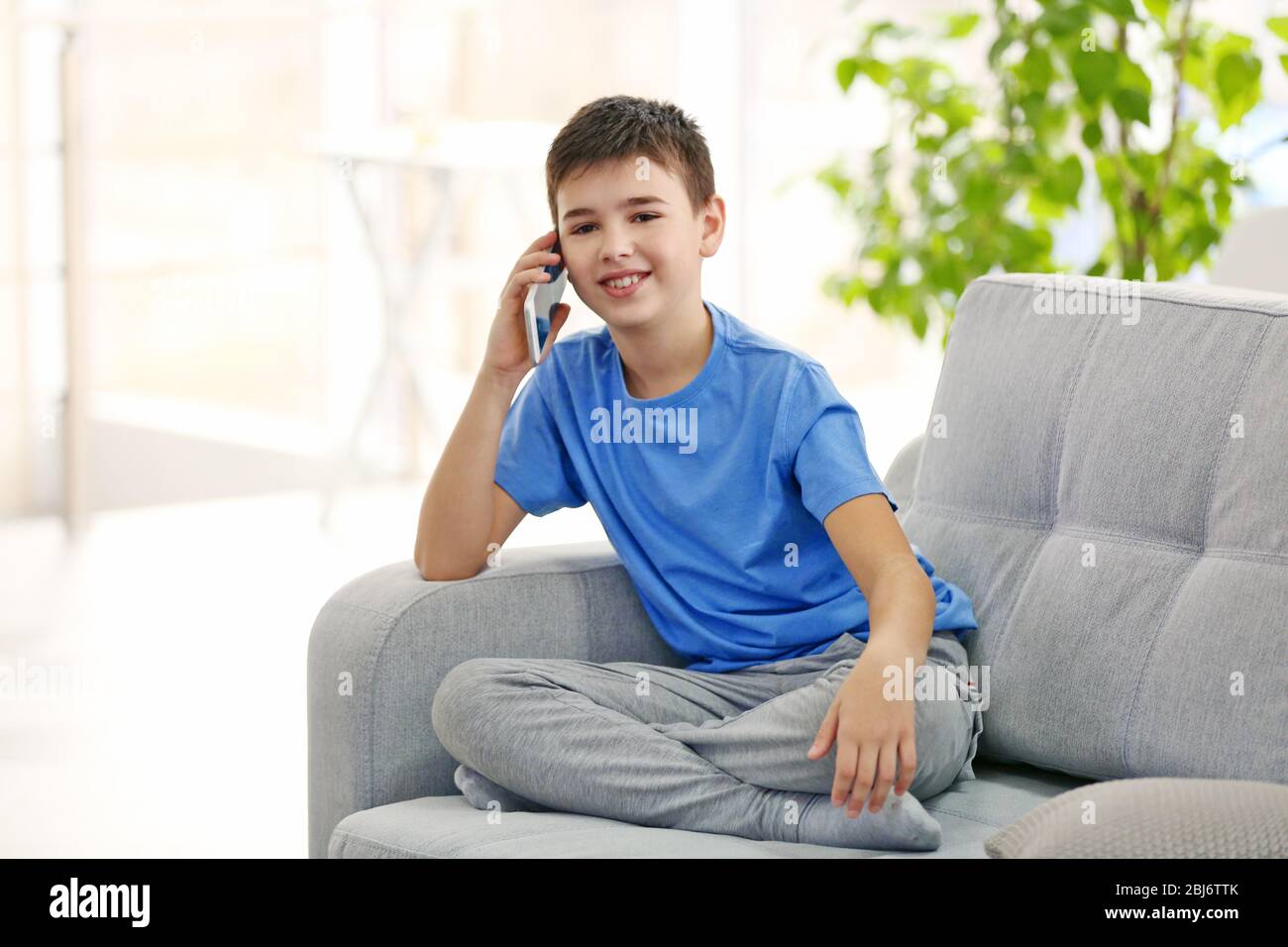 Boy phone sofa preteen hi-res stock photography and images - Alamy