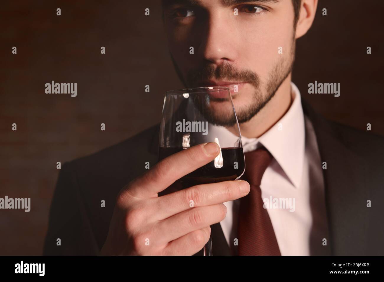 Man sniffing red wine in glass Stock Photo - Alamy
