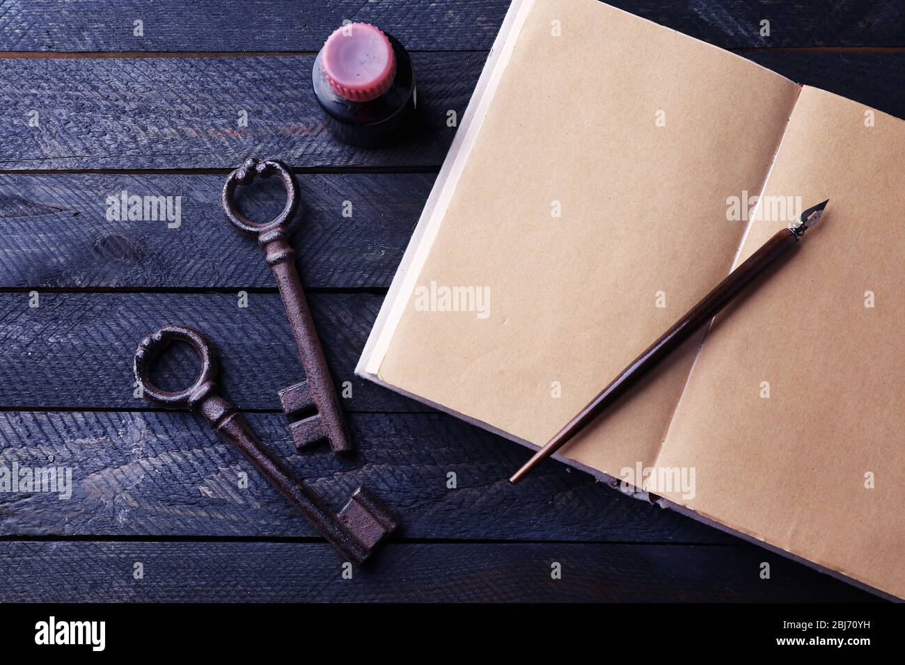 Old keys with papers, ink and pen on dark wooden background, close up ...