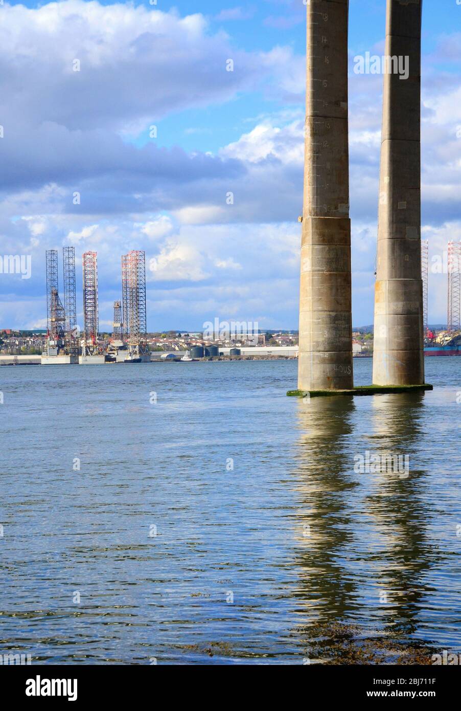Oil rig drilling platforms at Dundee Dockside with pier colums of Tay ...