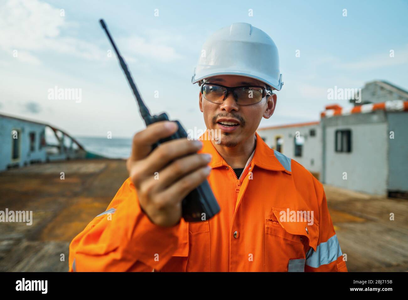 Filipino deck Officer on deck of vessel or ship , wearing PPE personal ...