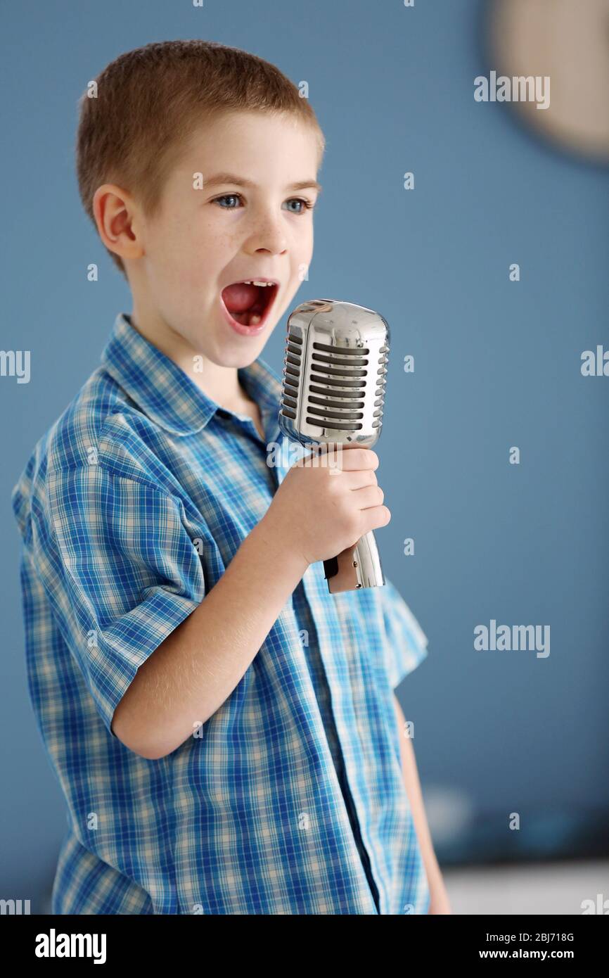 Little boy singing into the microphone at home Stock Photo - Alamy