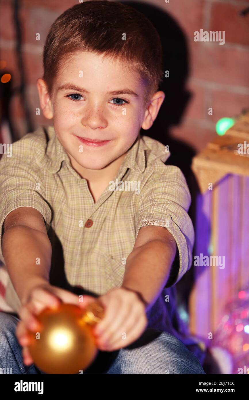 Little boy with yellow bauble at home Stock Photo - Alamy