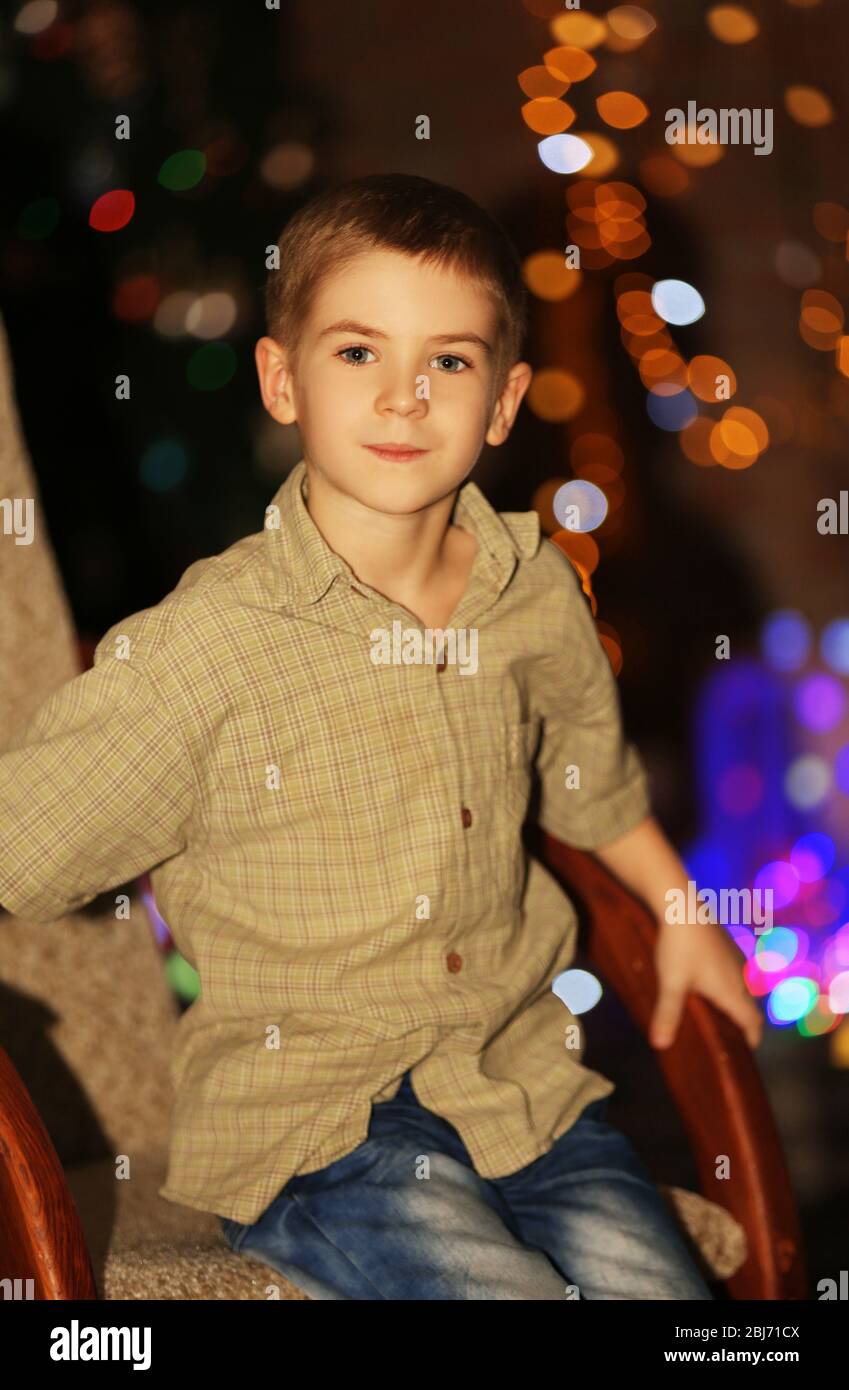 Little boy in rock chair at home on a blurred background Stock Photo ...
