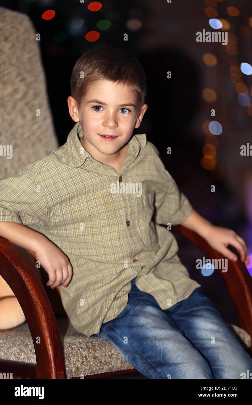 Little boy in rock chair at home on a blurred background Stock Photo ...