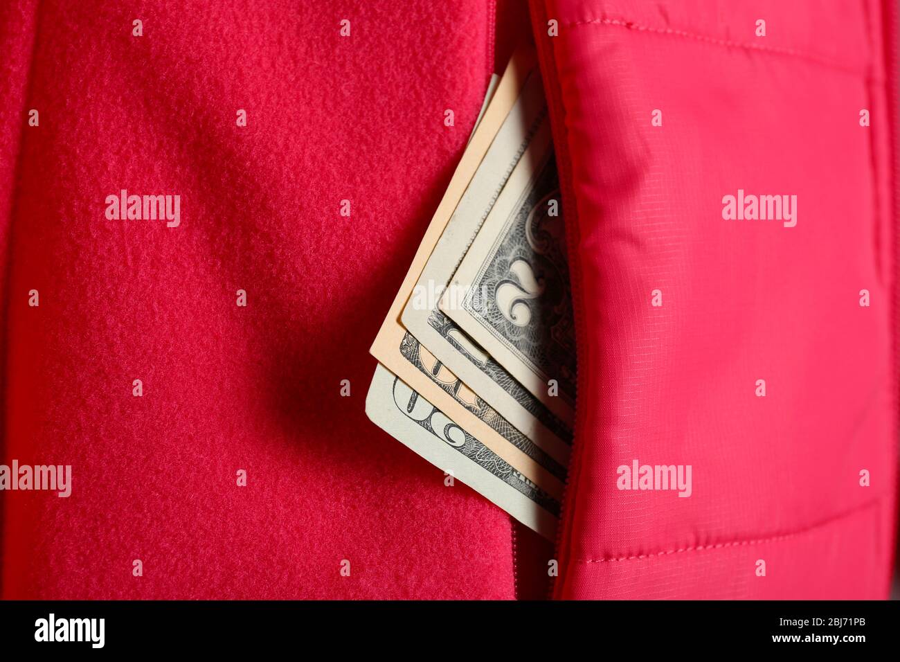 Cash in the red jacket pocket, close up Stock Photo - Alamy