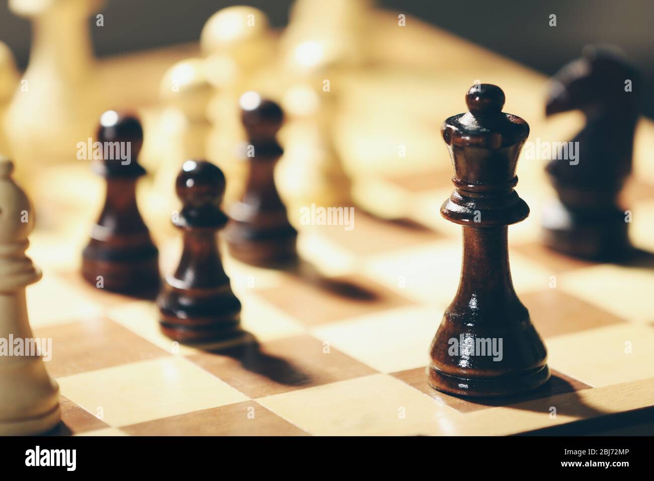 Chess pieces and game board on soft blurred background Stock Photo - Alamy