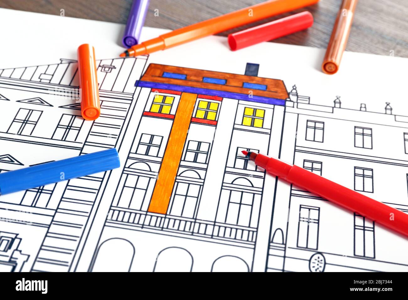 Coloring of buildings with felt pens on wooden table Stock Photo - Alamy