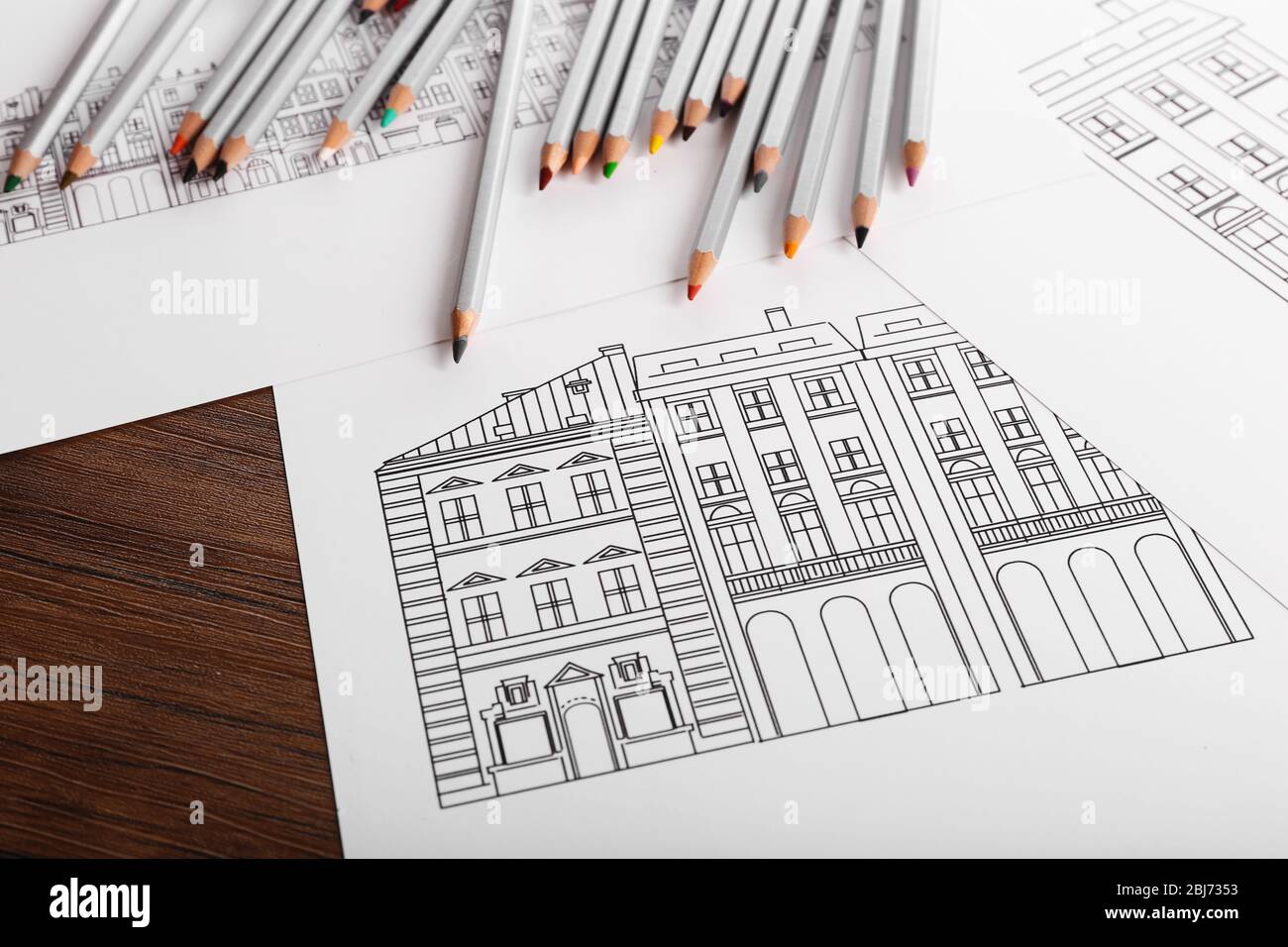 Drawing of buildings and colour pencils on wooden table Stock Photo - Alamy