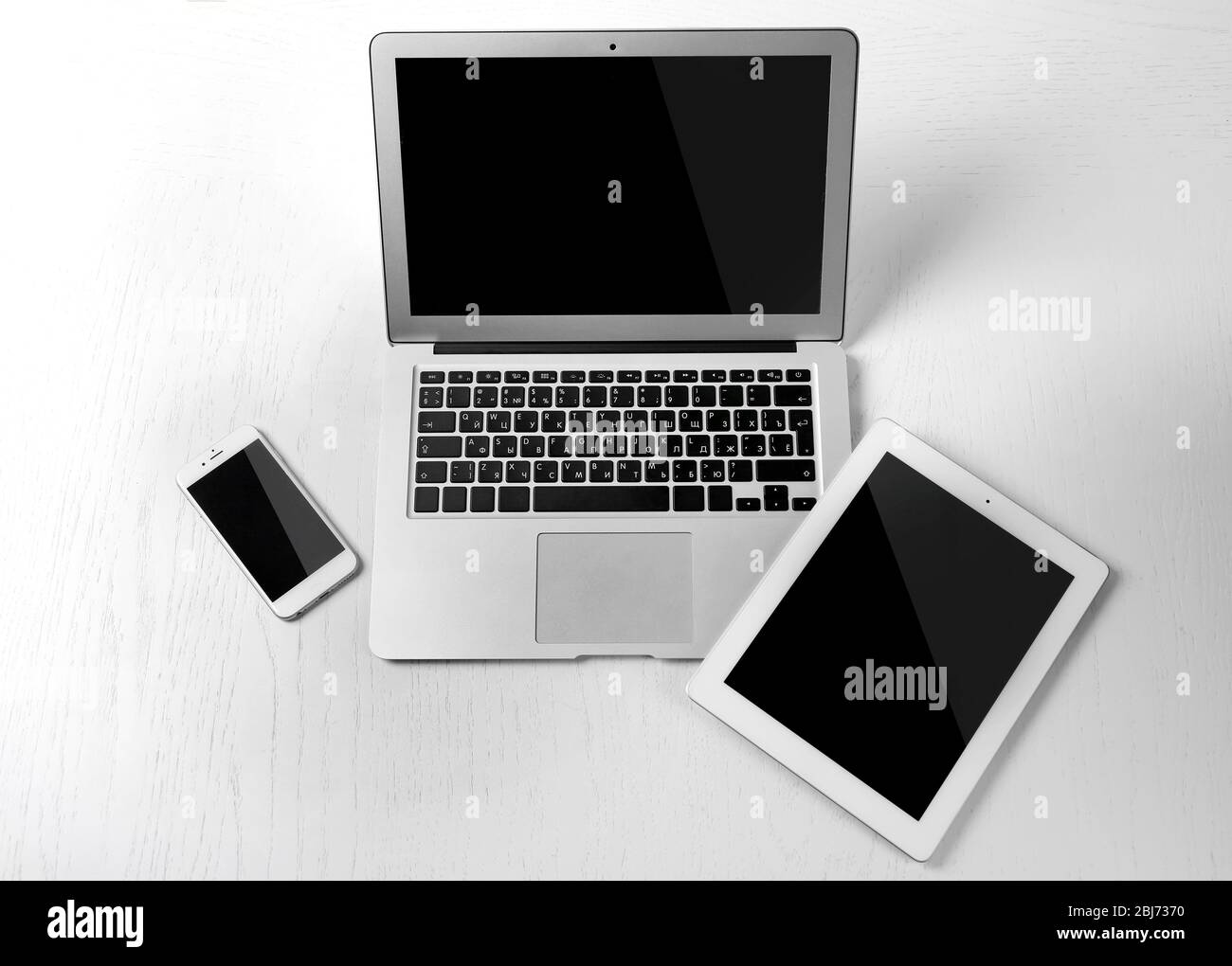 Different modern devices on light table Stock Photo - Alamy