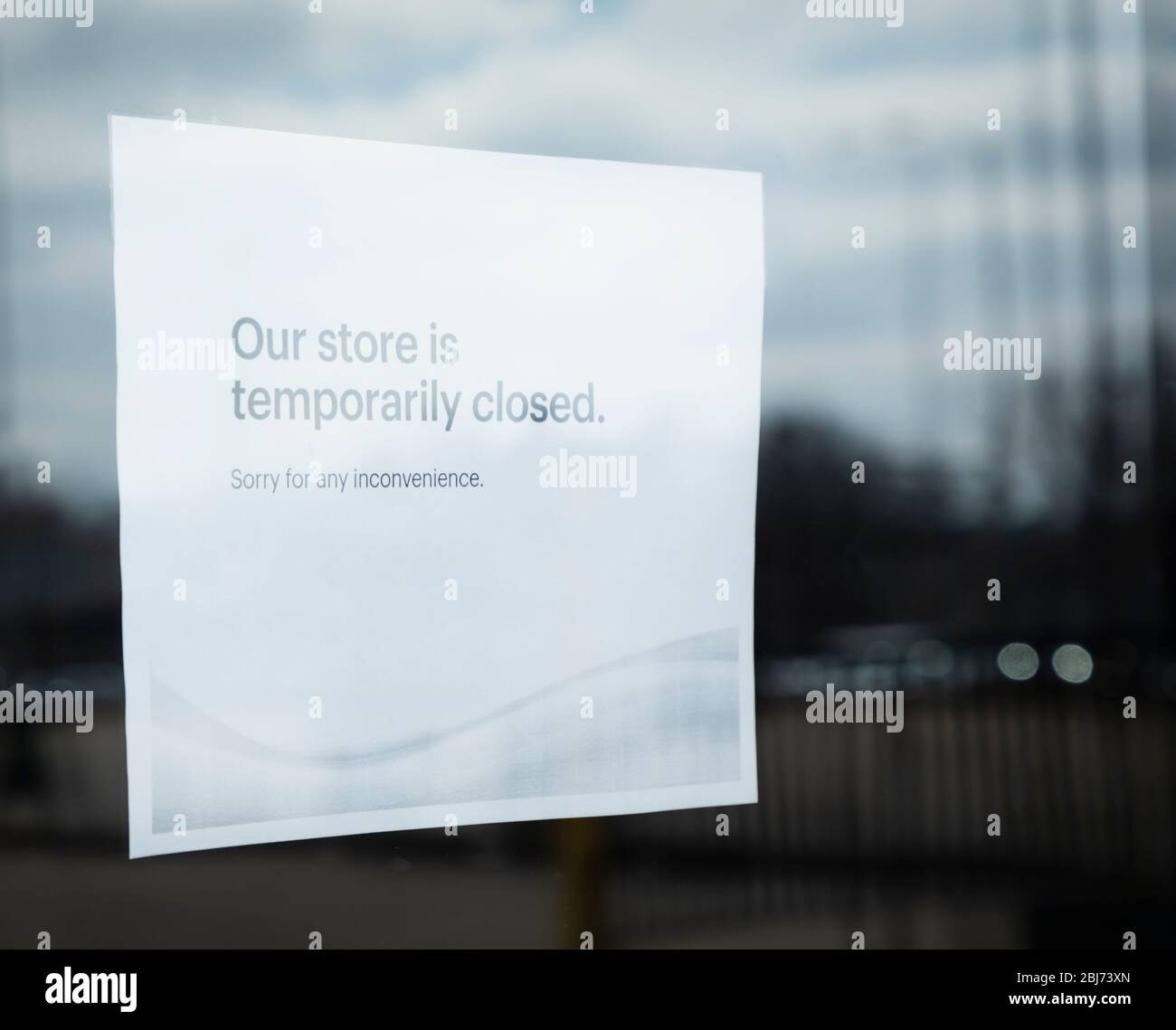 Store closure notice on glass door informs customers about temporary ...