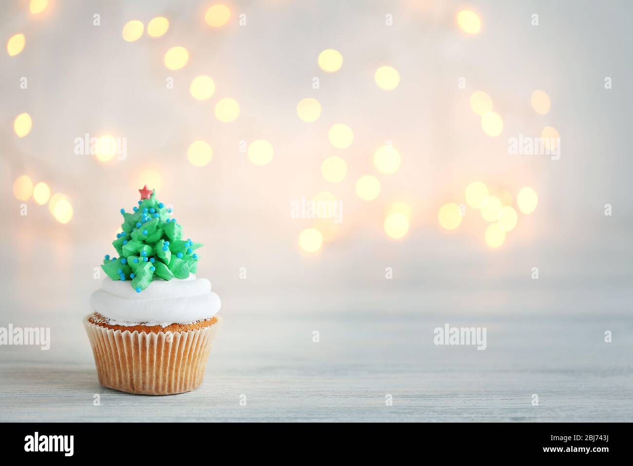 Christmas cupcake with lights on background Stock Photo - Alamy