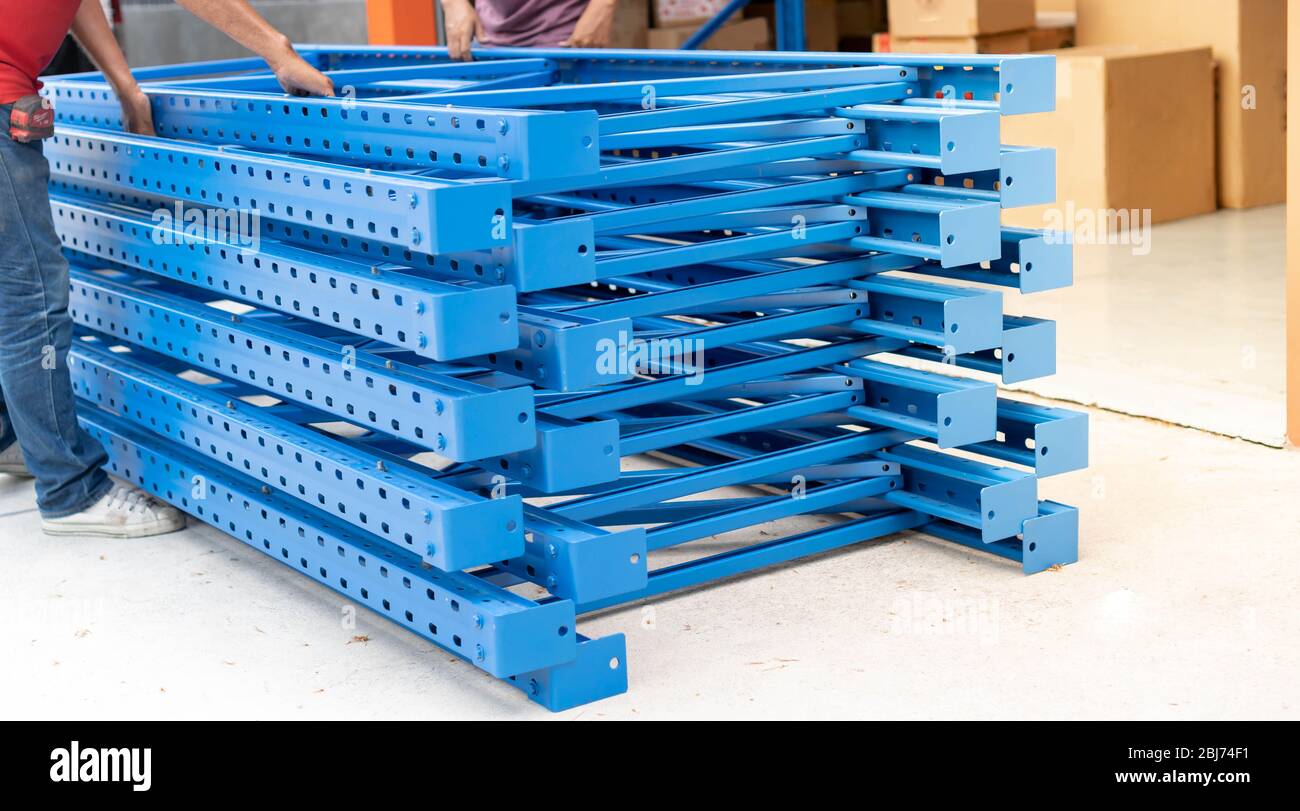 Male hand holding pile of the metal rack prepare for assemble to metal ...