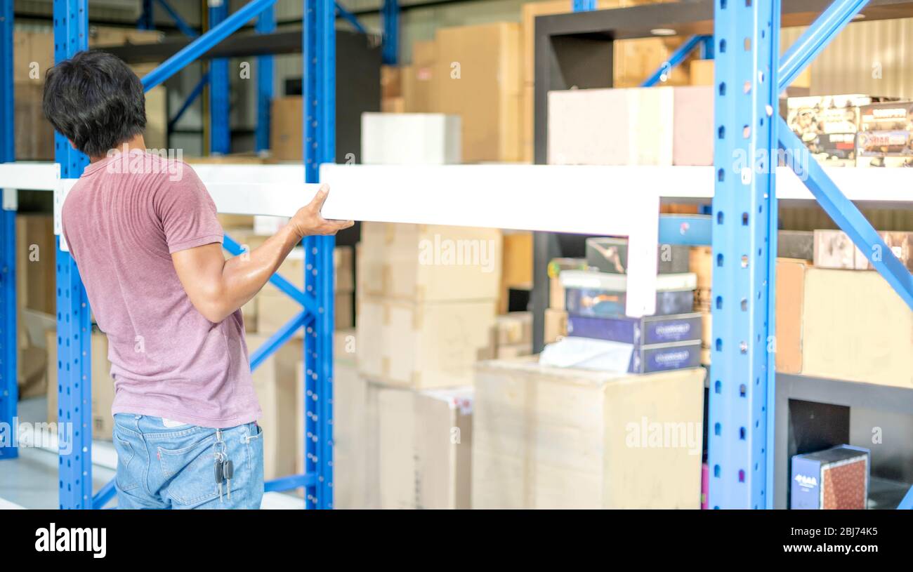 Male hand holding prepare to assembling the metal rack in warehouse or ...