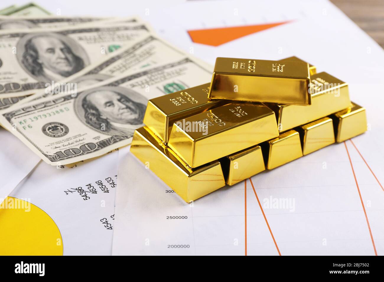 Gold bars with dollar banknotes on paper background Stock Photo - Alamy