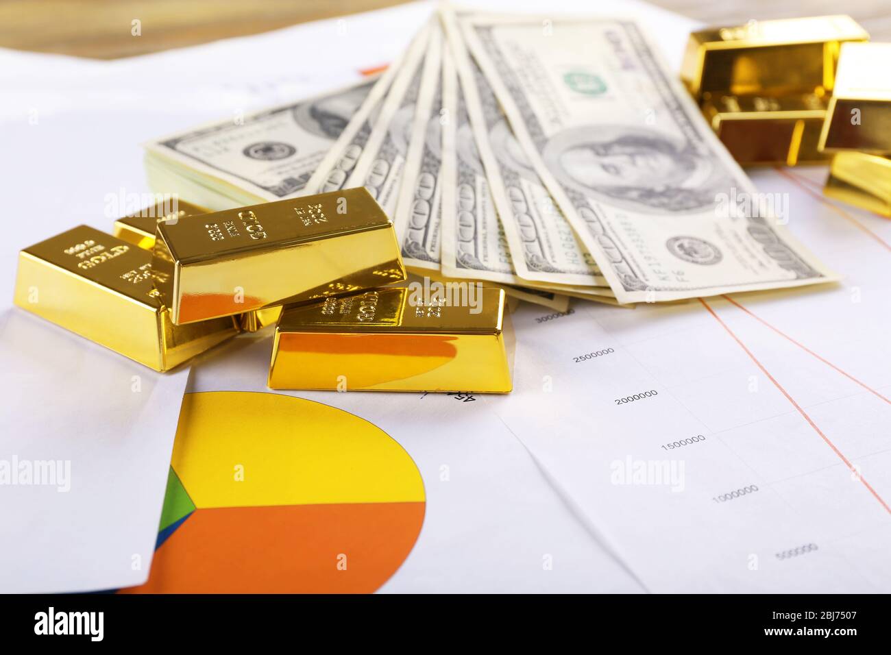 Gold bars with dollar banknotes on paper background Stock Photo - Alamy