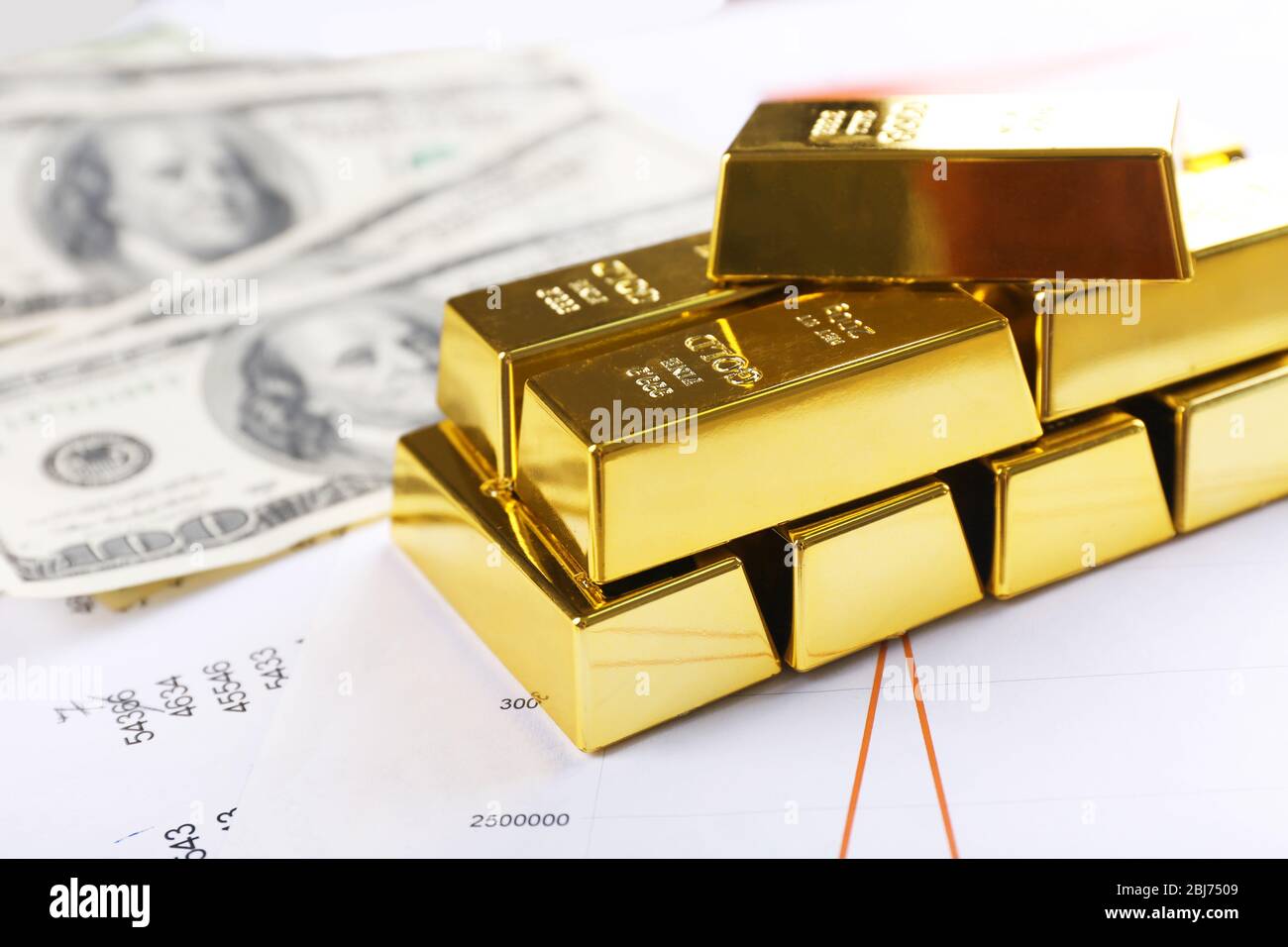 Gold bars with dollar banknotes on paper background Stock Photo - Alamy