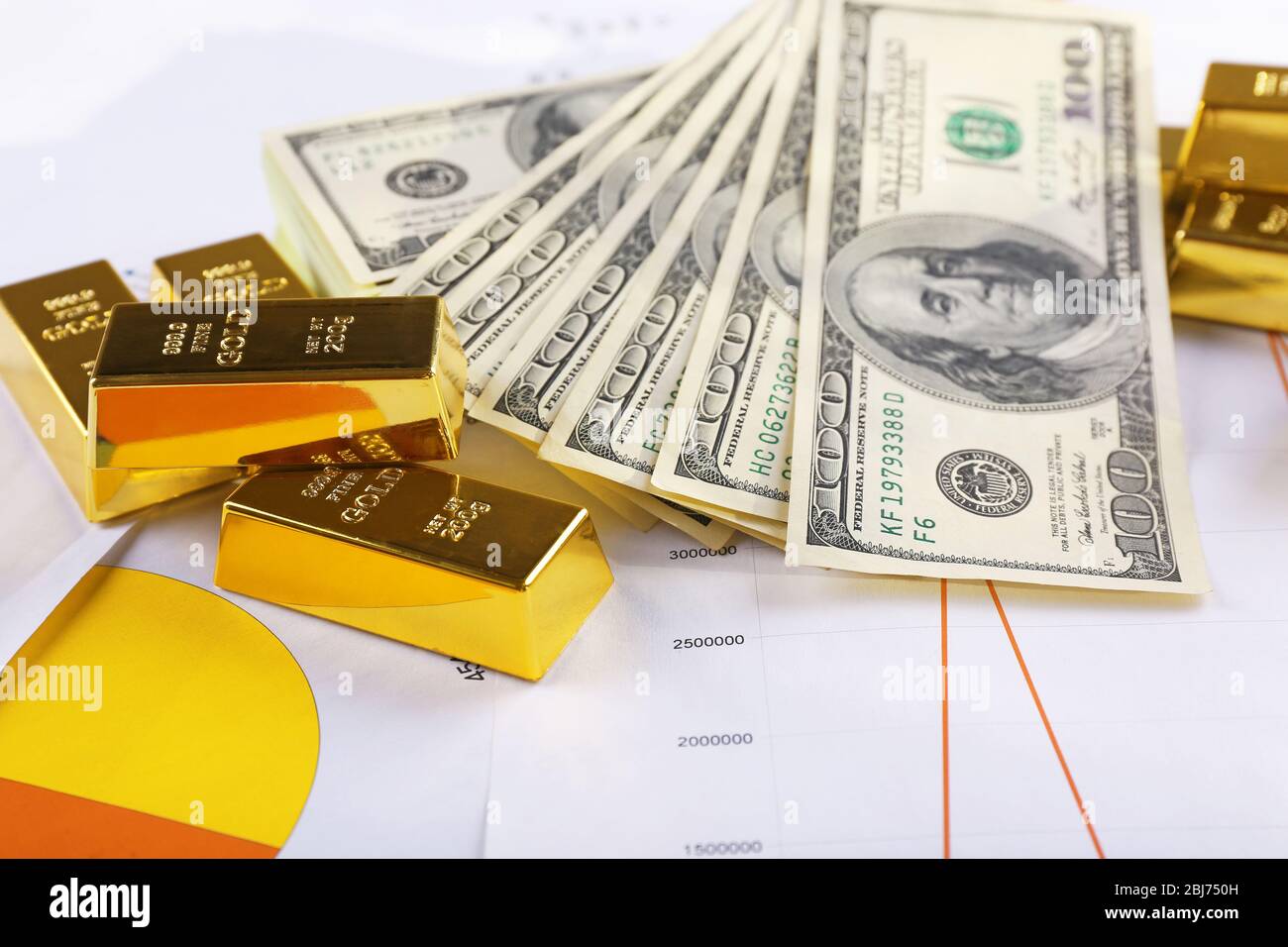 Gold bars with dollar banknotes on paper background Stock Photo - Alamy