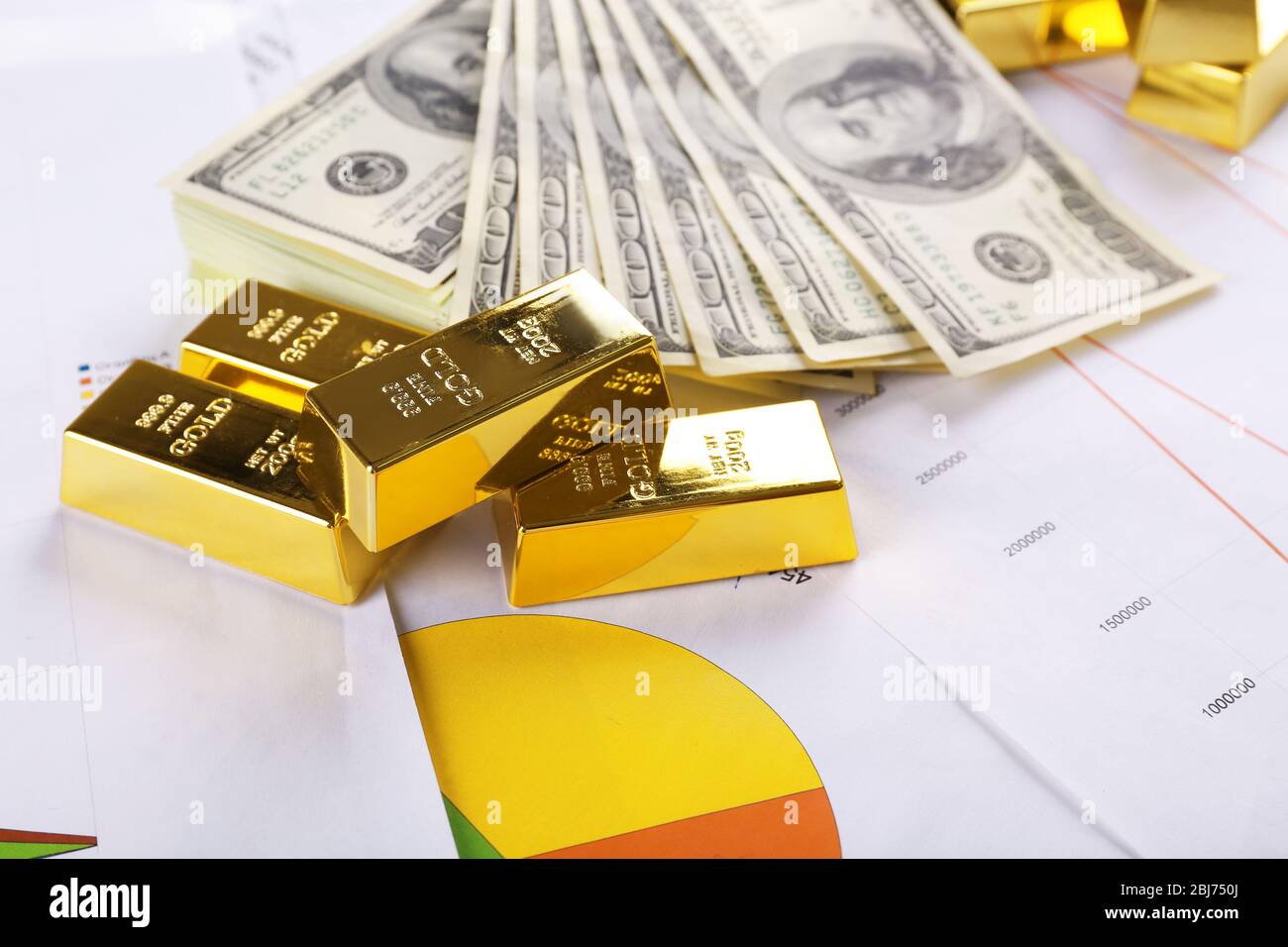 Gold bars with dollar banknotes on paper background Stock Photo - Alamy