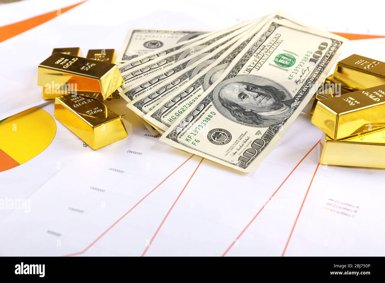 Gold bars with dollar banknotes on paper background Stock Photo - Alamy