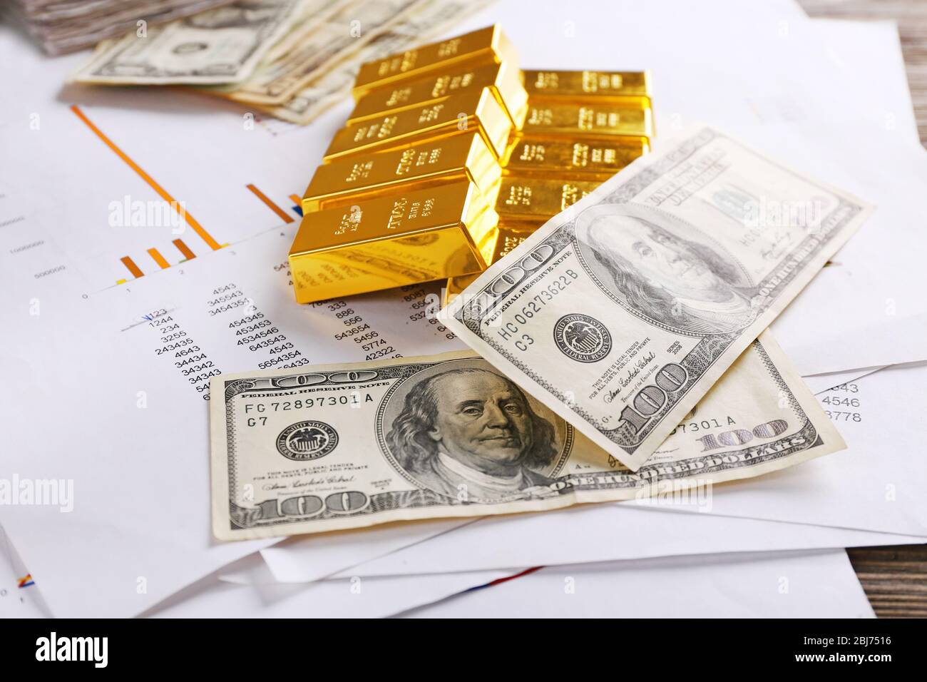 Gold bars with dollar banknotes on paper background Stock Photo - Alamy