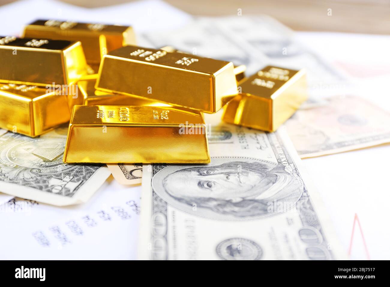 Gold bars on dollar banknotes, close up Stock Photo - Alamy