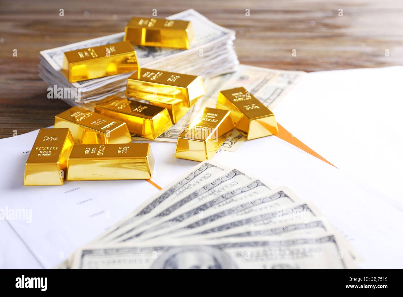 Gold bars with dollar banknotes on paper background Stock Photo - Alamy