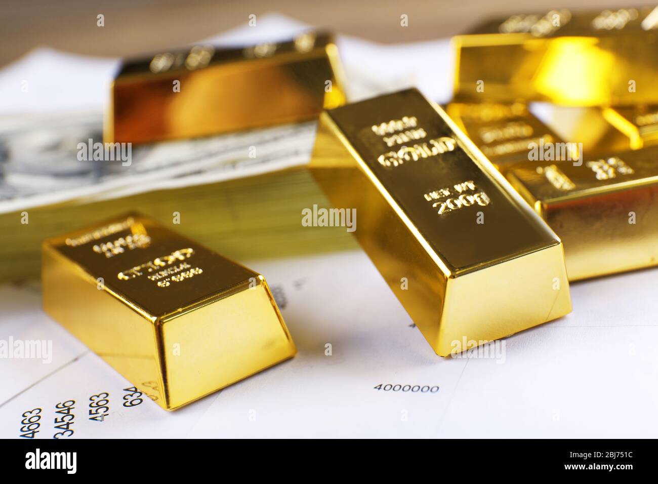 Gold bars with dollar banknotes on paper background, close up Stock ...