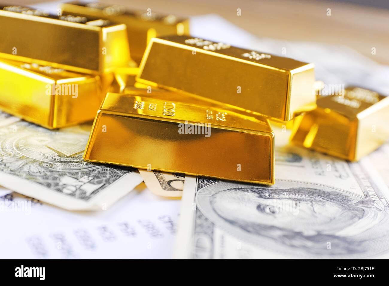 Gold bars on dollar banknotes, close up Stock Photo - Alamy