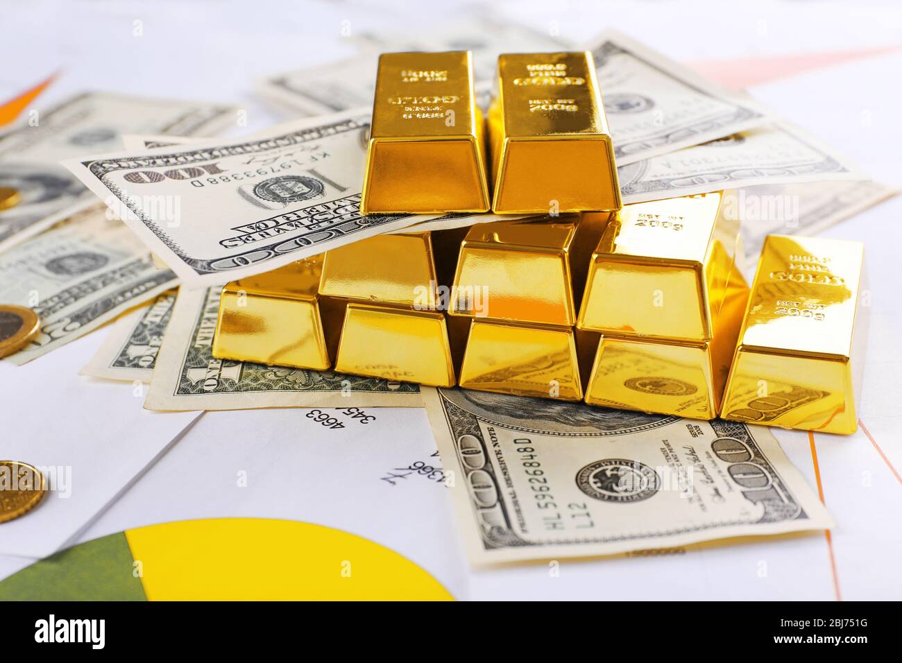 Gold bars with dollar banknotes on paper background Stock Photo - Alamy