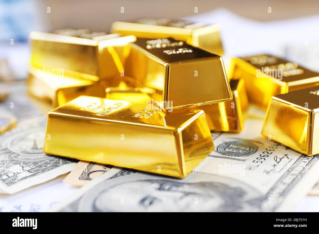 Gold bars on dollar banknotes, close up Stock Photo - Alamy
