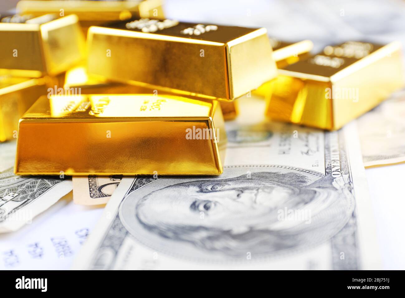 Gold bars on dollar banknotes, close up Stock Photo - Alamy