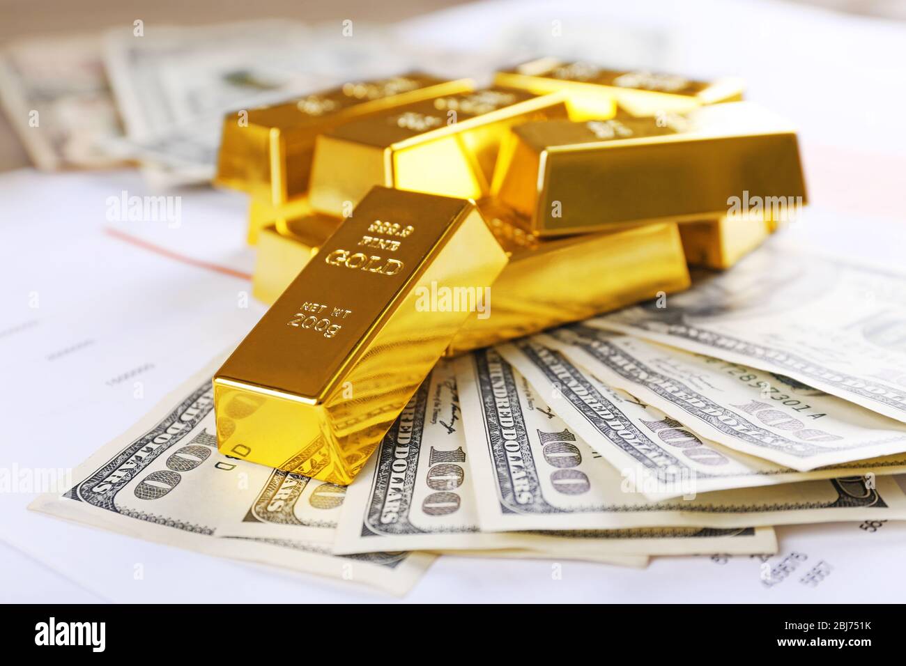 Gold bars with dollar banknotes on paper background Stock Photo - Alamy
