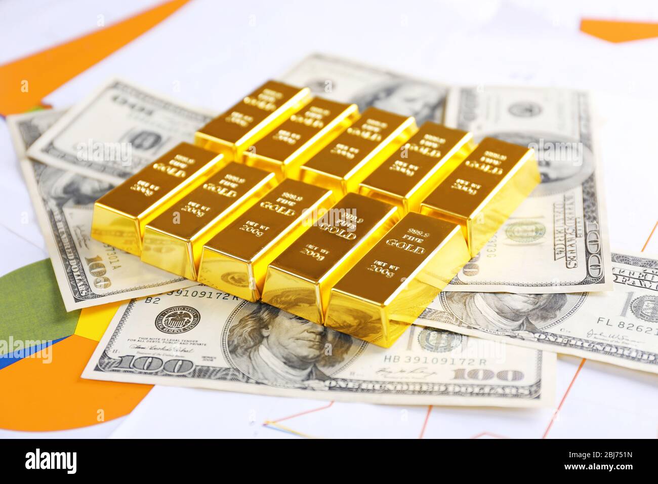 Gold bars with dollar banknotes on paper background Stock Photo - Alamy