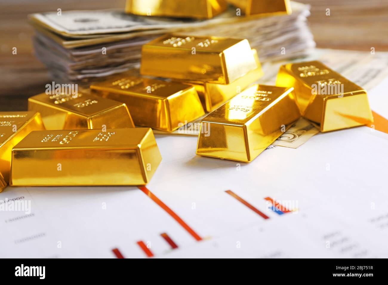 Gold bars with dollar banknotes on paper background Stock Photo - Alamy