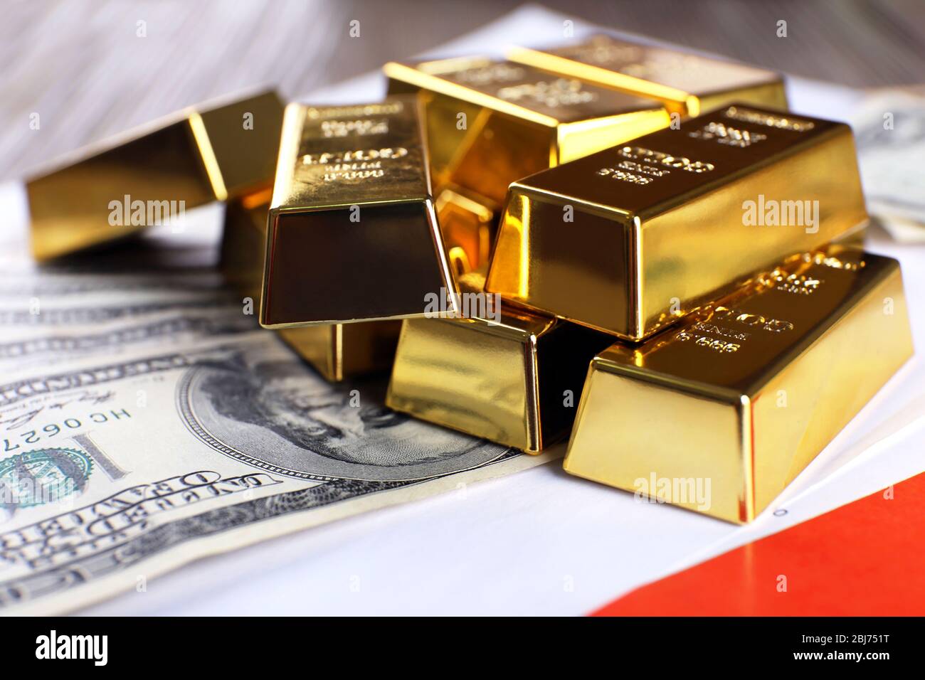 Gold bars with dollar banknotes on paper background Stock Photo - Alamy