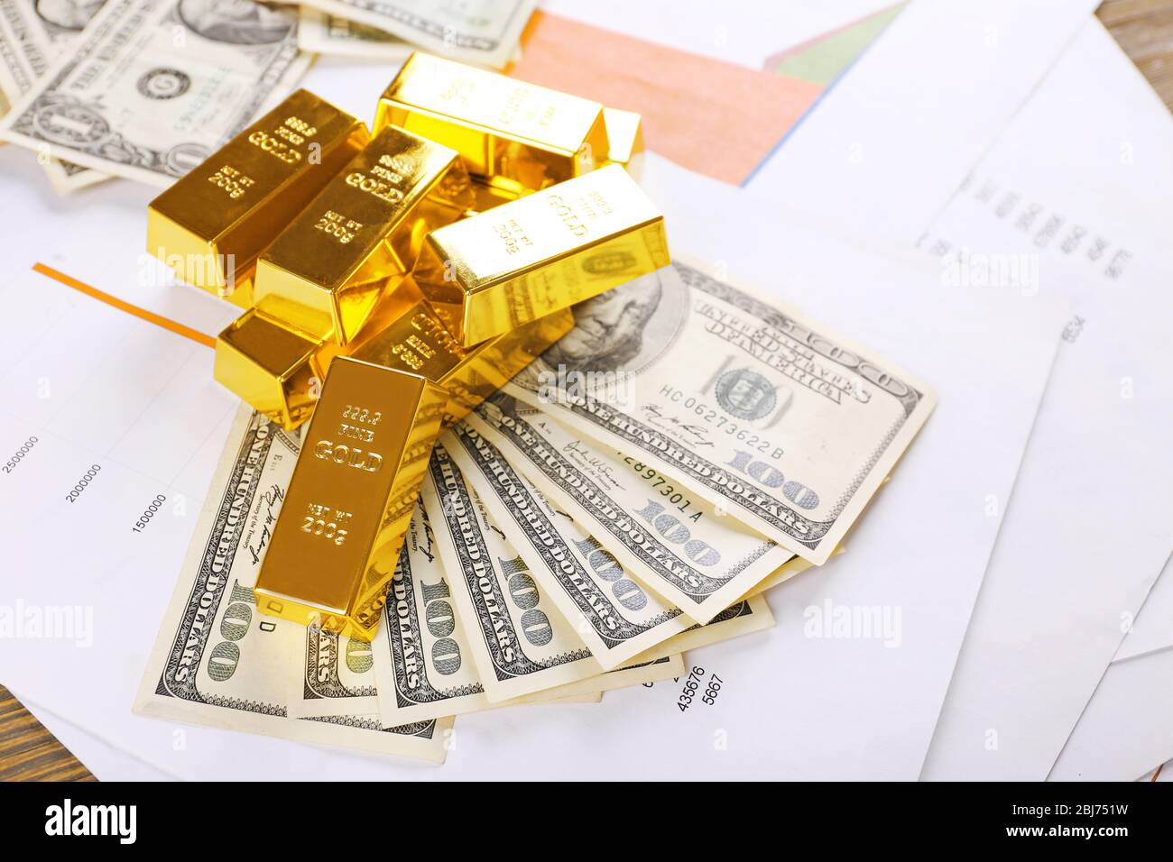 Gold bars with dollar banknotes on paper background Stock Photo - Alamy