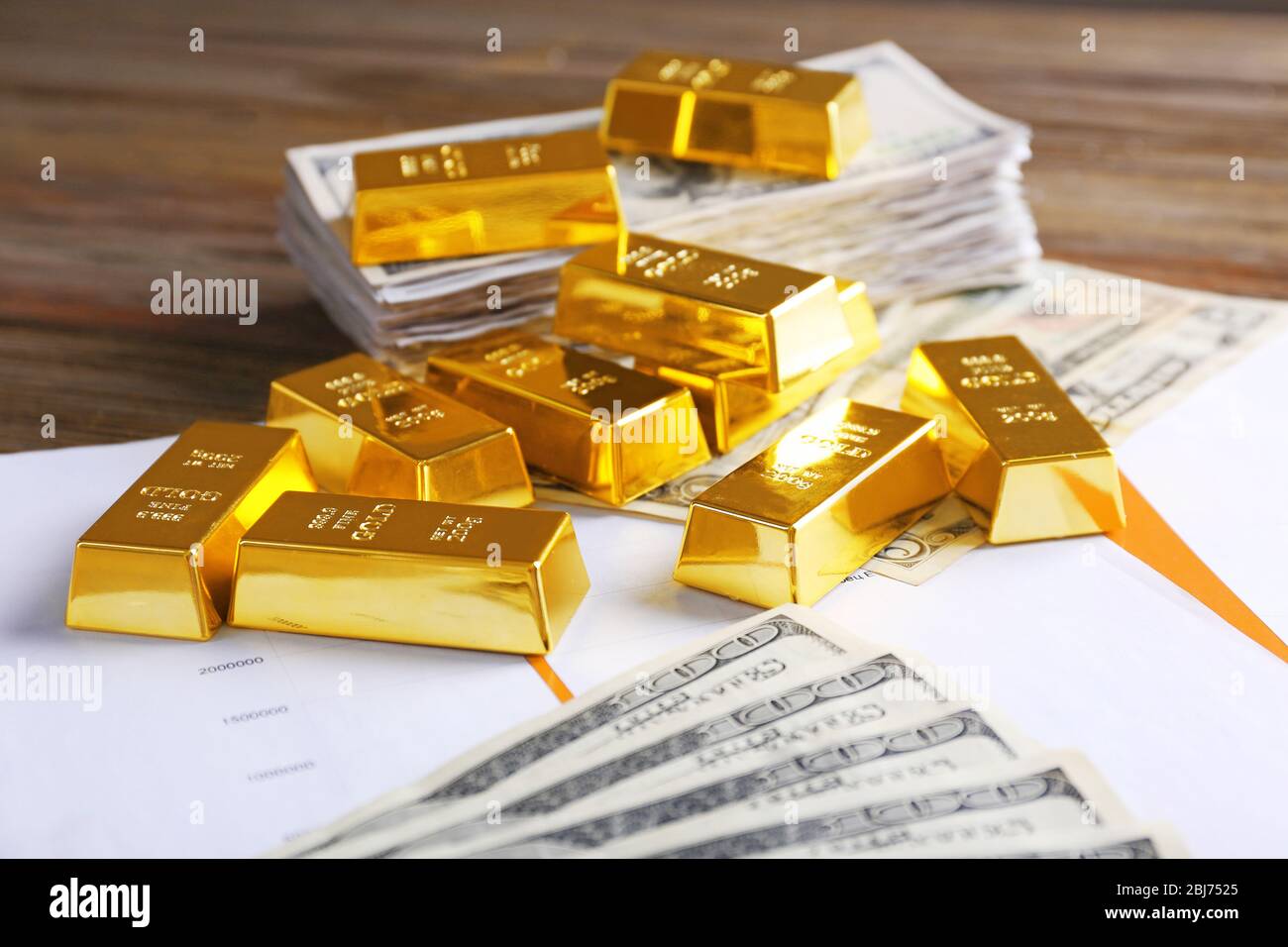 Gold bars with dollar banknotes on paper background Stock Photo - Alamy