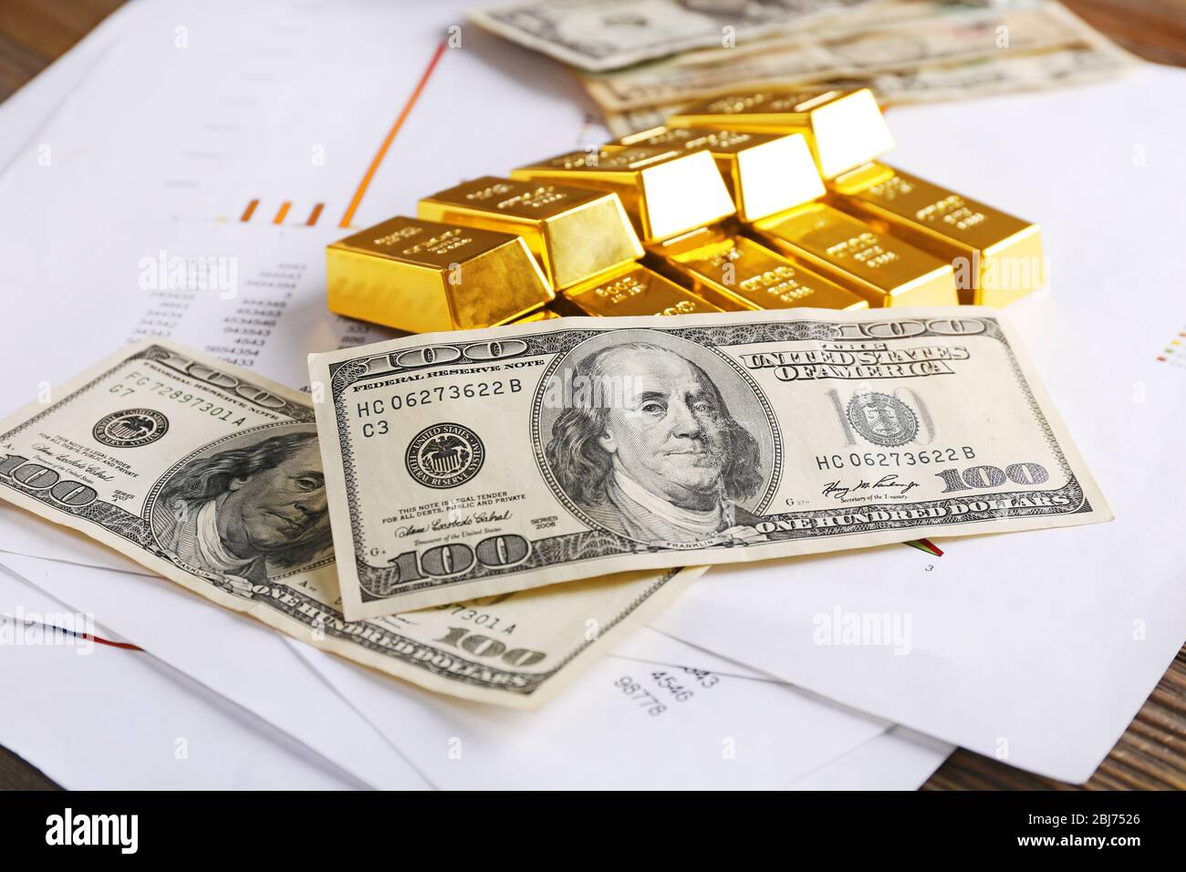Gold bars with dollar banknotes on paper background Stock Photo - Alamy