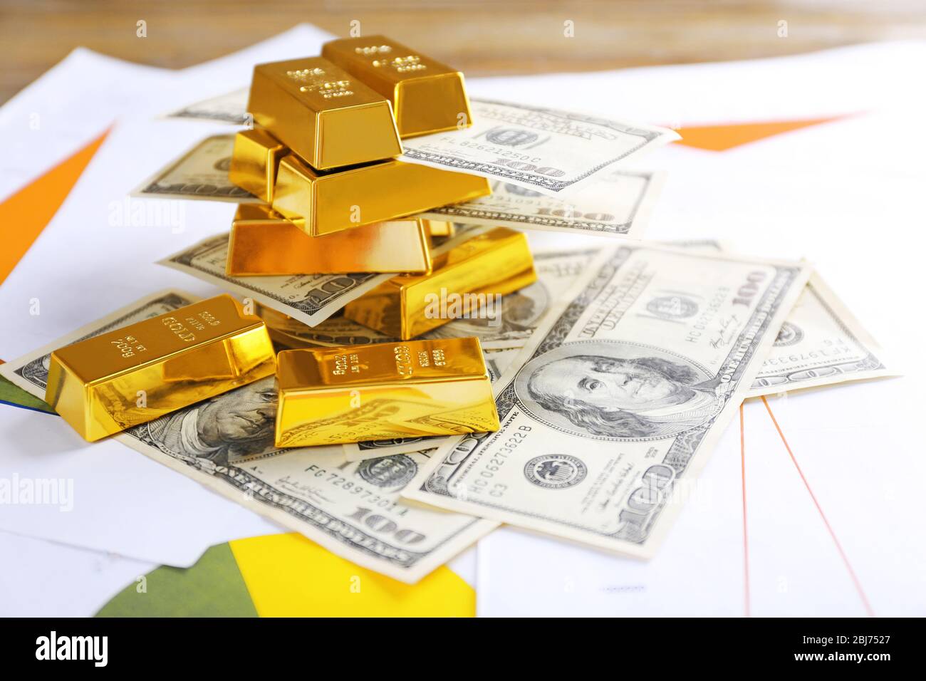 Gold bars with dollar banknotes on paper background Stock Photo - Alamy