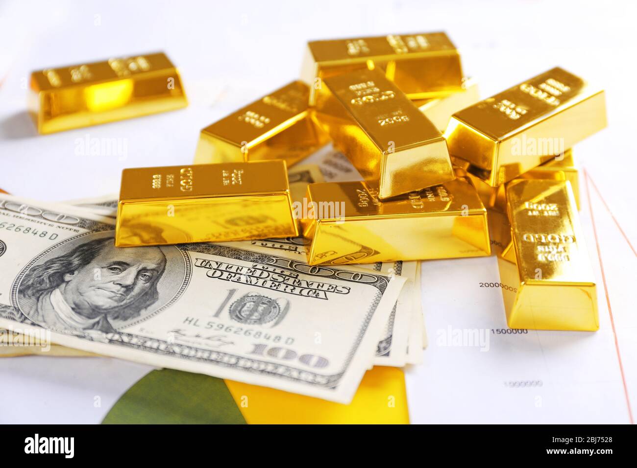 Gold bars with dollar banknotes on paper background Stock Photo - Alamy
